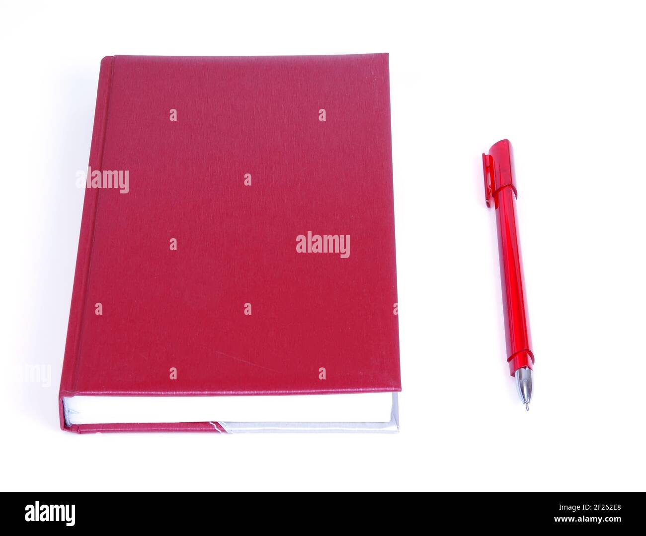 red notebook for reference daily notes with a pen on a white background ...