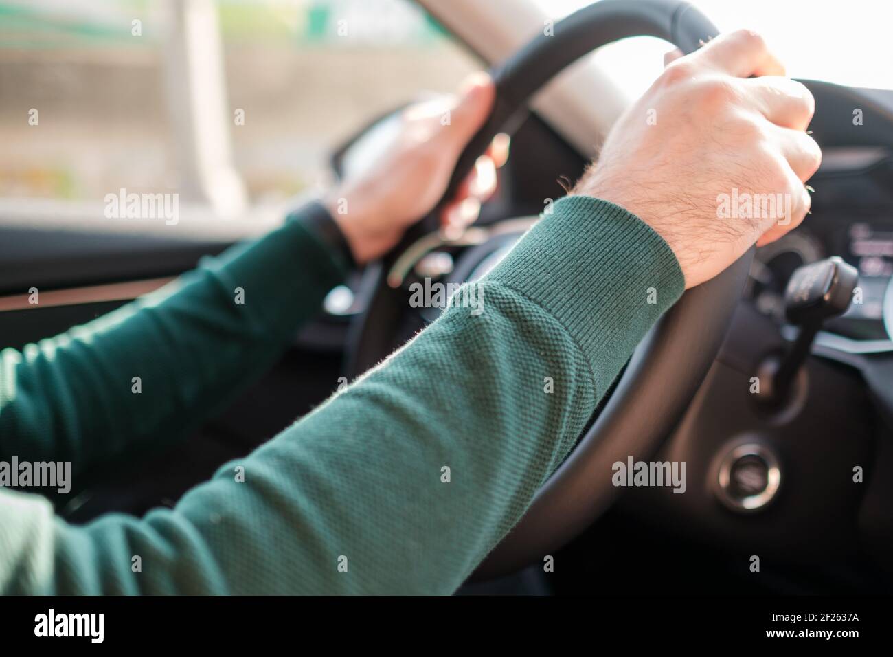 Close up mans hands on the wheel, driving a car Stock Photo - Alamy