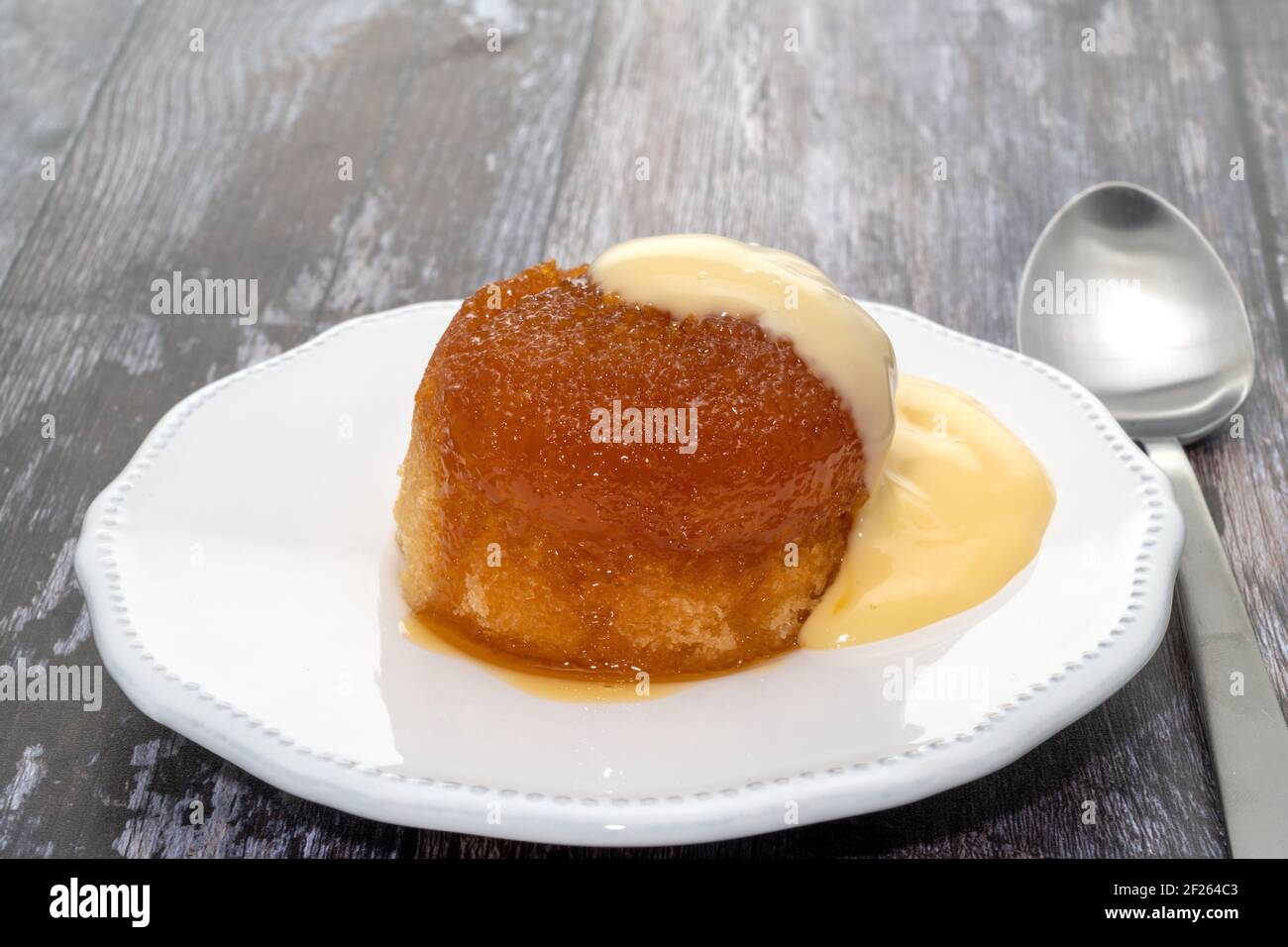 Syrup sponge with dairy custard Stock Photo - Alamy