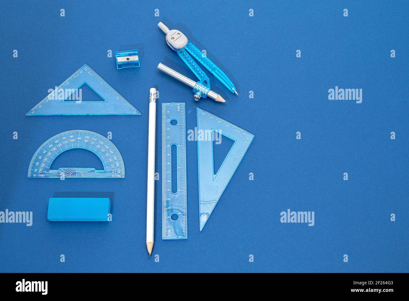 A plastic geometry set place on a clear blue background Stock Photo - Alamy