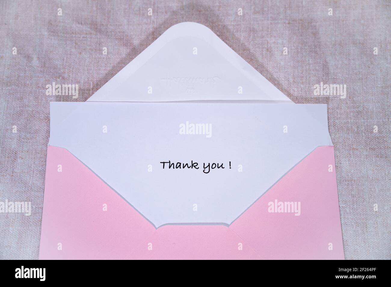 A Thank You note in a pink envelope Stock Photo - Alamy