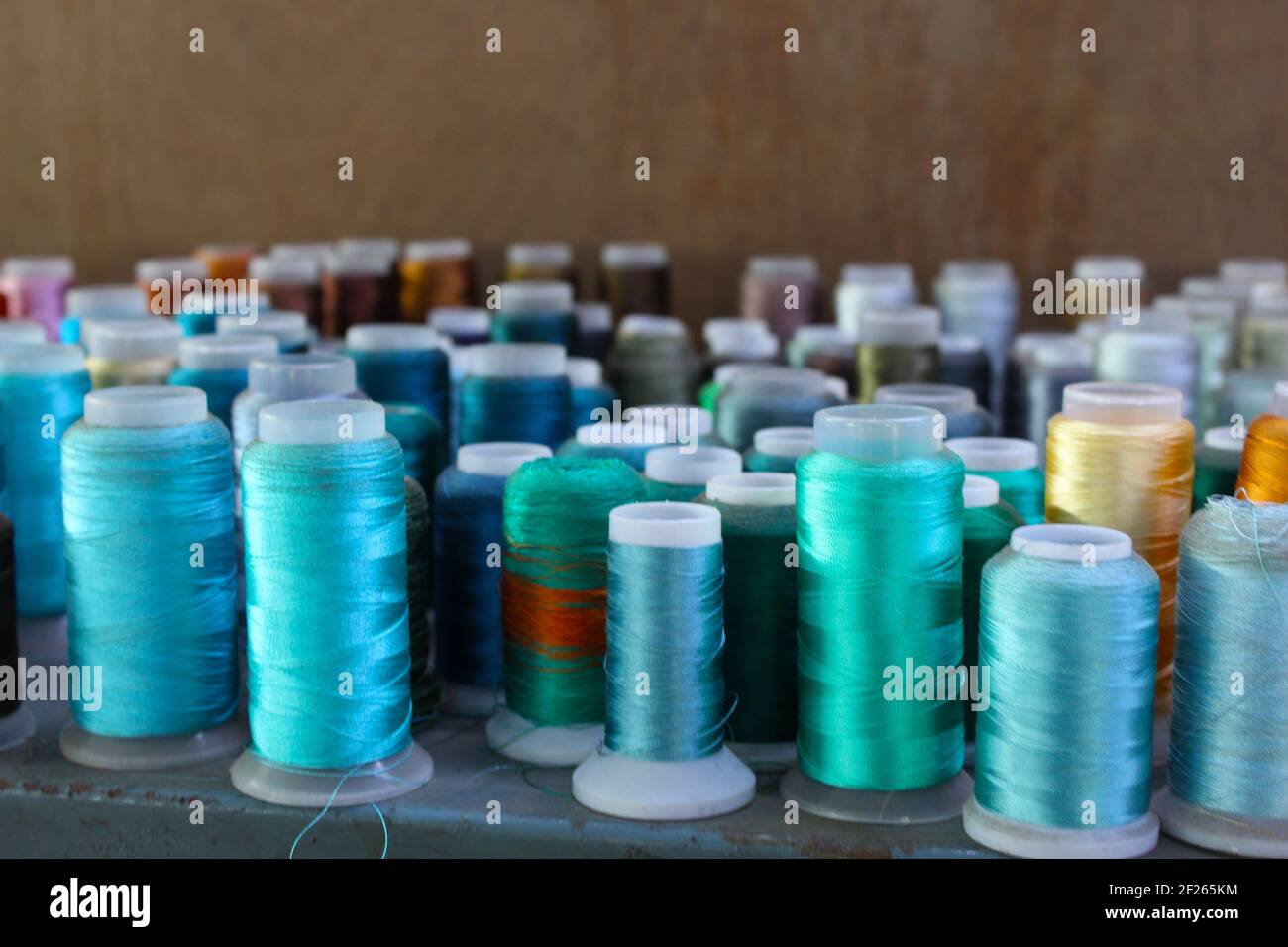 different color spools of thread for the textile industry. background ...
