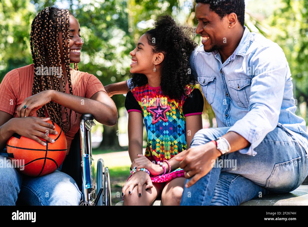 Woman in a wheelchair at the park with family Stock Photo - Alamy