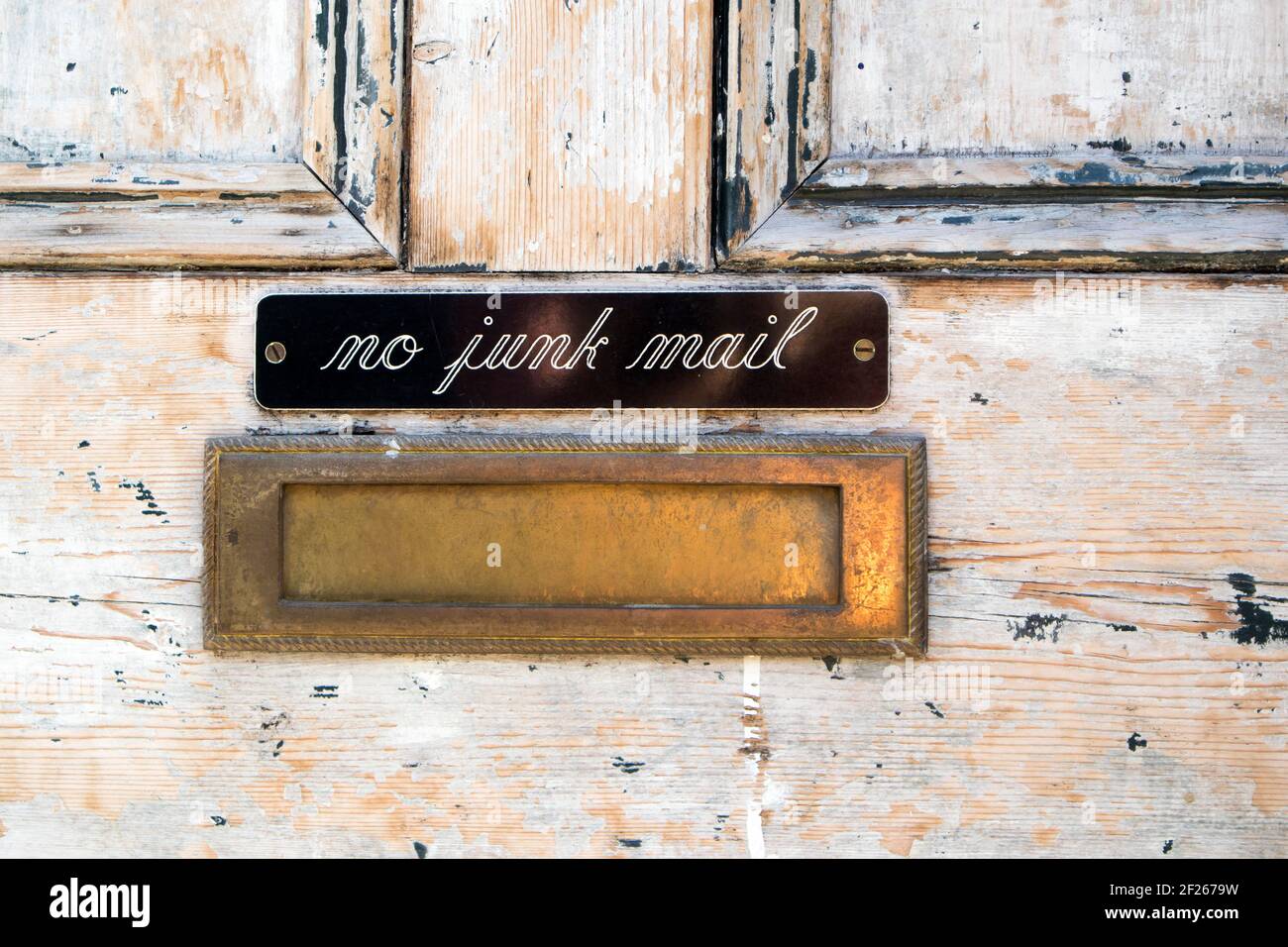 House letterbox with 'No junk mail' sign at a white vintage door Stock ...