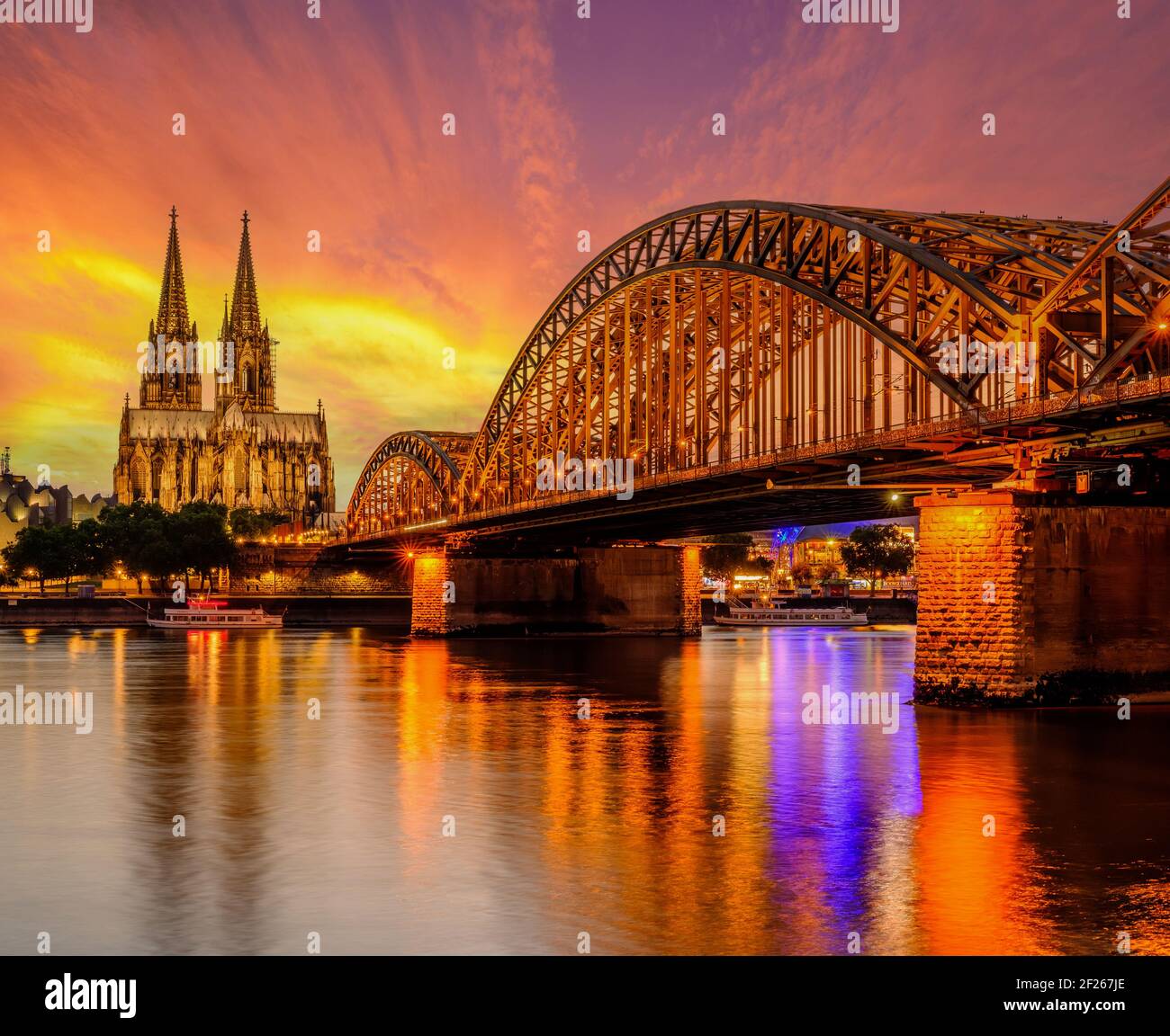 Cologne Cathedral and Hohenzollern Bridge at sunset, Germany Stock ...