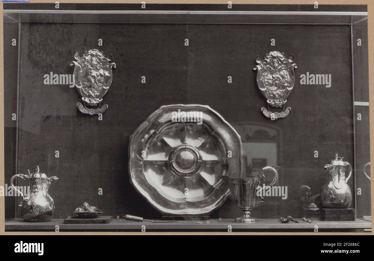 Showcase with silver objects, including jugs, a scale and funeral ...