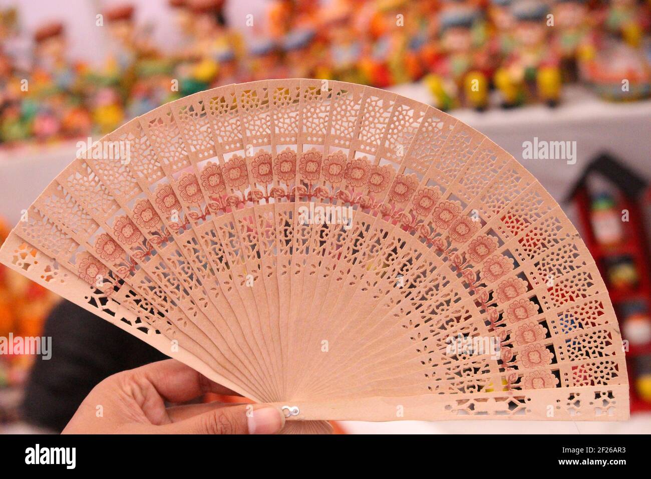 wooden hand fan isolated on light background Stock Photo - Alamy