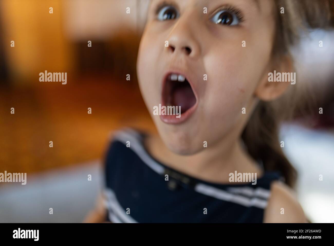 Close-up of a cute and surprised little girl with mouth open Stock ...