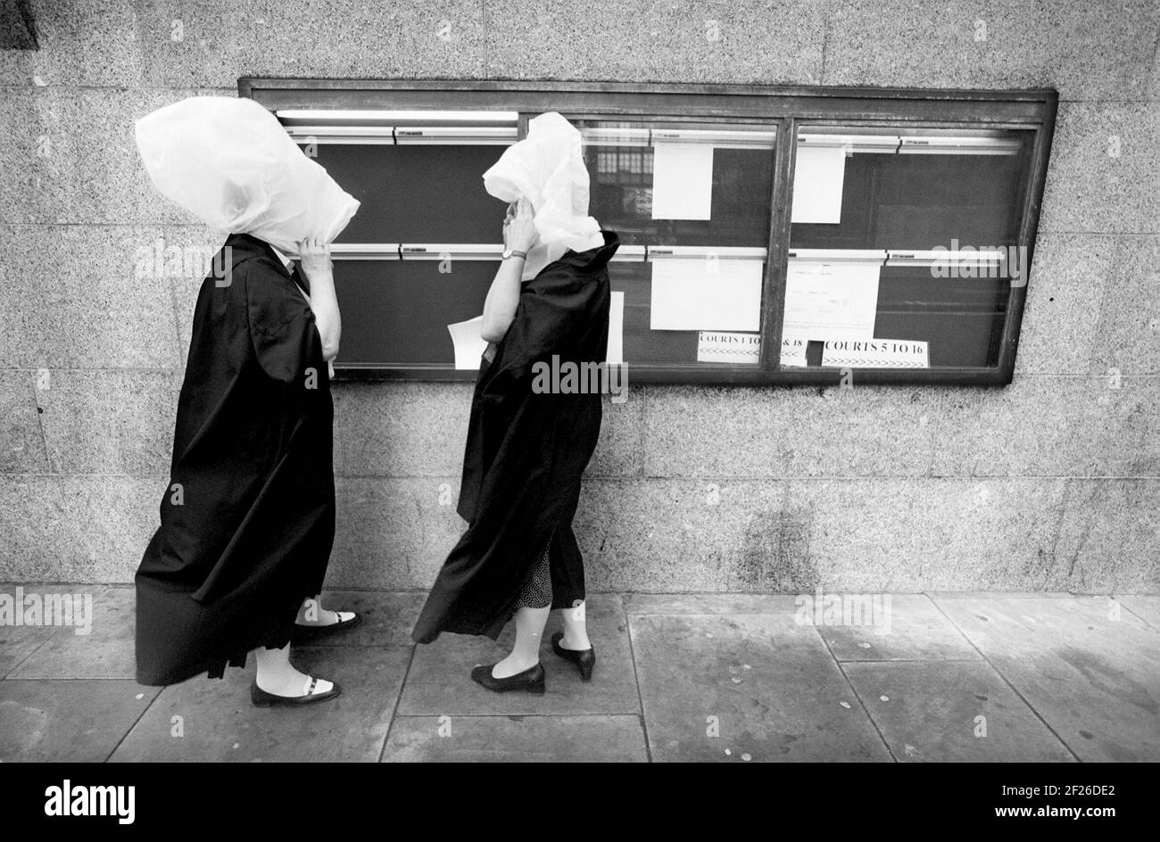 TWO COURT USHERS CHANGE THE INFORMATION OUTSIDE THE OLD BAILEY ...