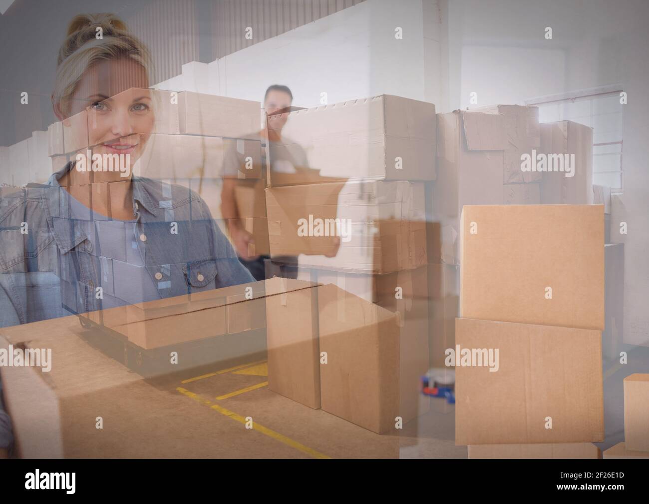 Composition of couple carrying cardboard boxes over stack boxes in ...