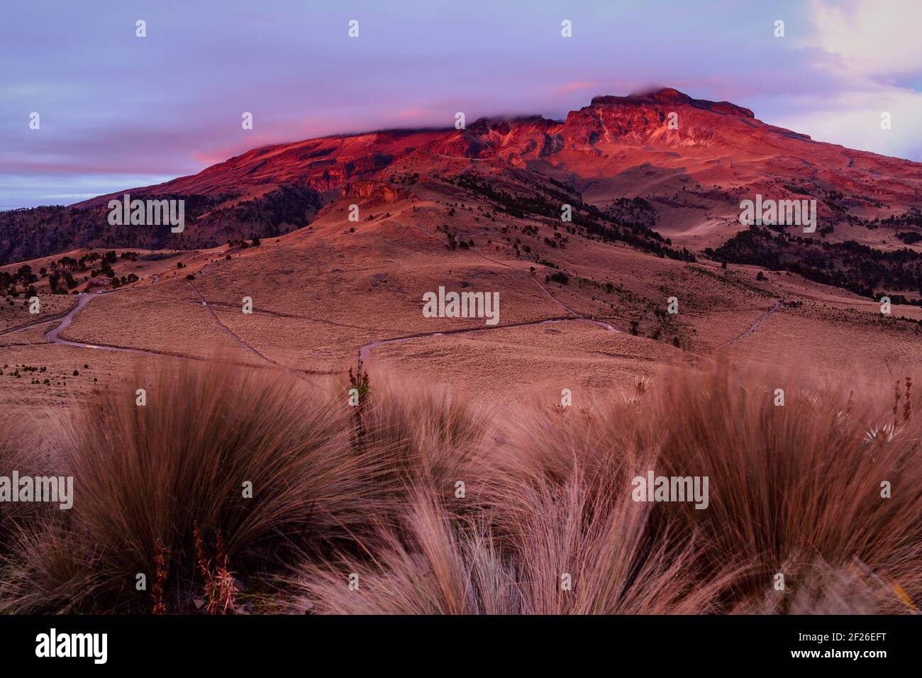 Climbing Iztaccíhuatl volcano in Mexico at sunset in pastel colours ...