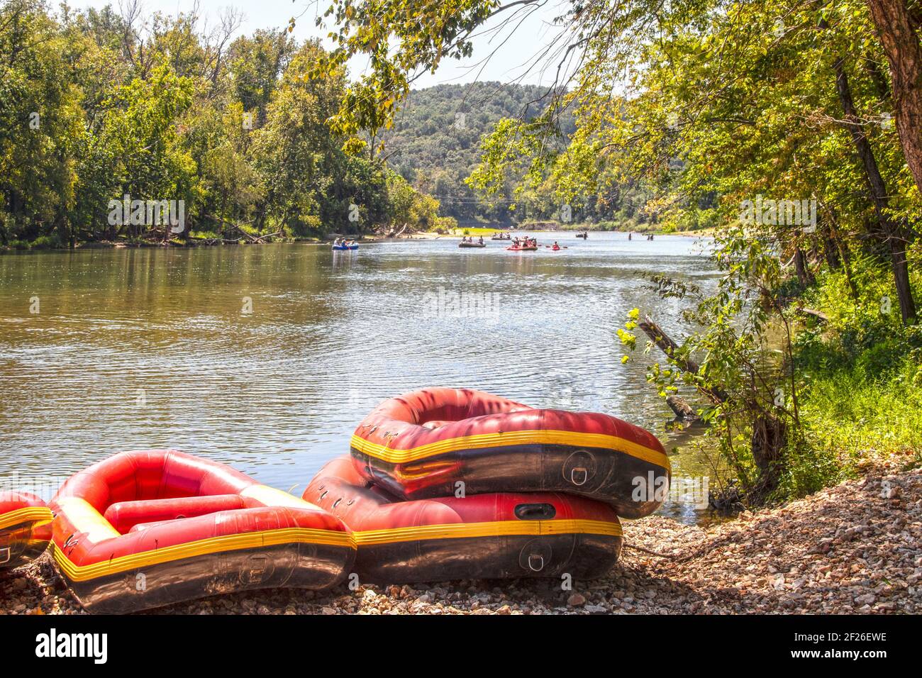 Boat rafts piled on river bank and boats full of rafters and swimmers ...