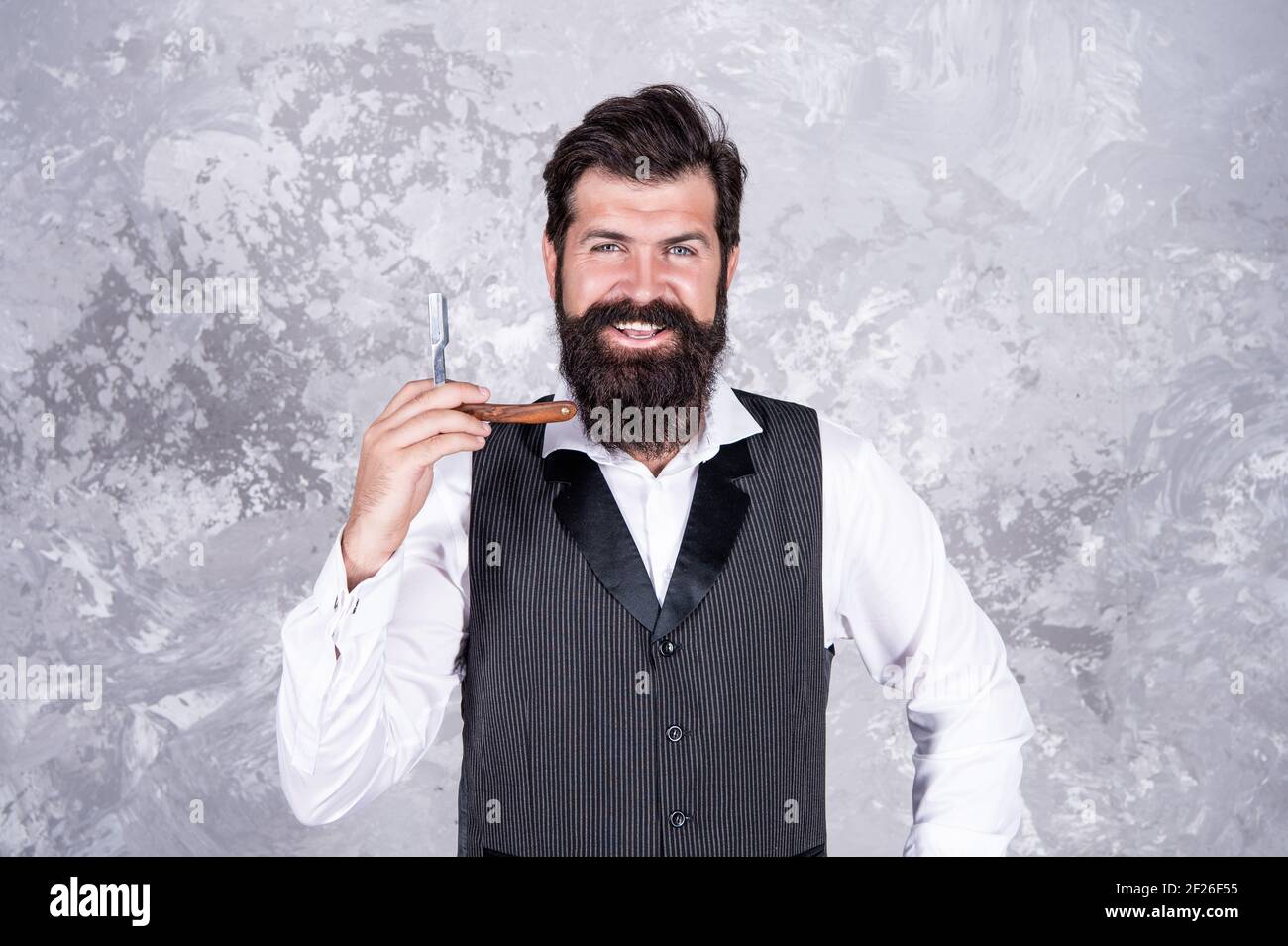 happy handsome brutal man barber with beard and moustache hold ...