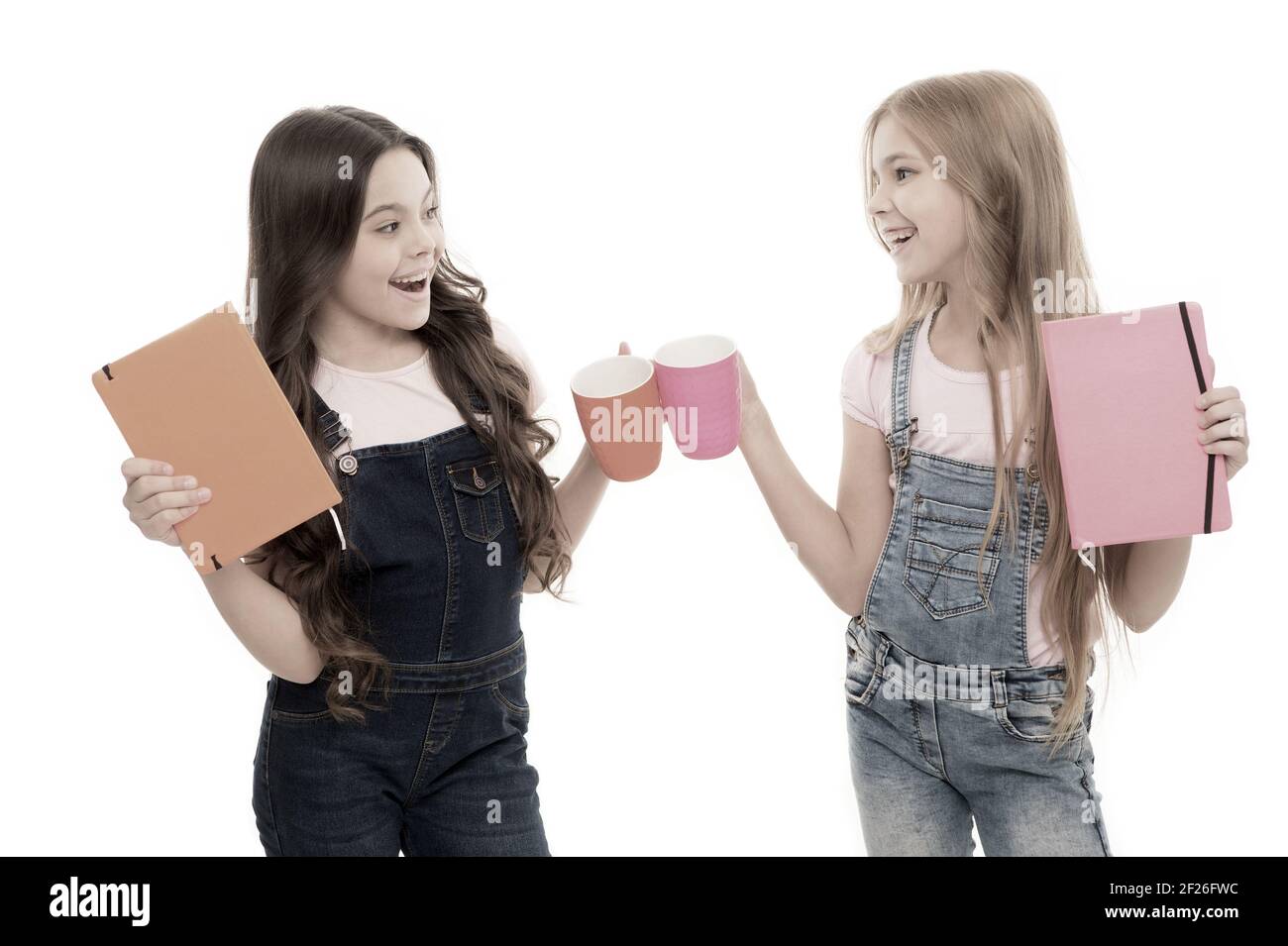 Chin chin. Little girls having tea break. Small children chinking cups ...