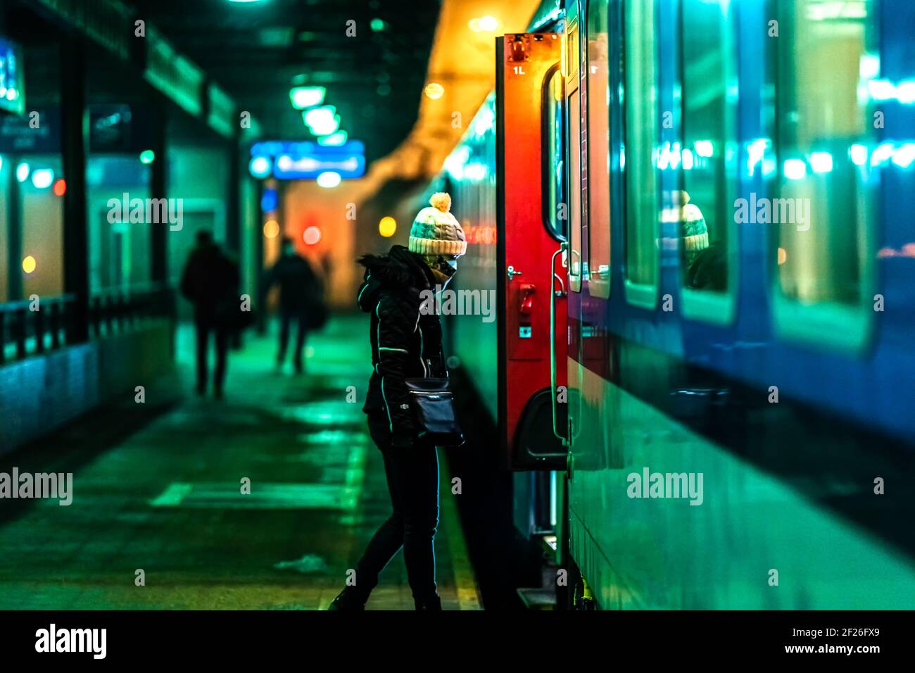woman boarding a night train at the station Stock Photo - Alamy