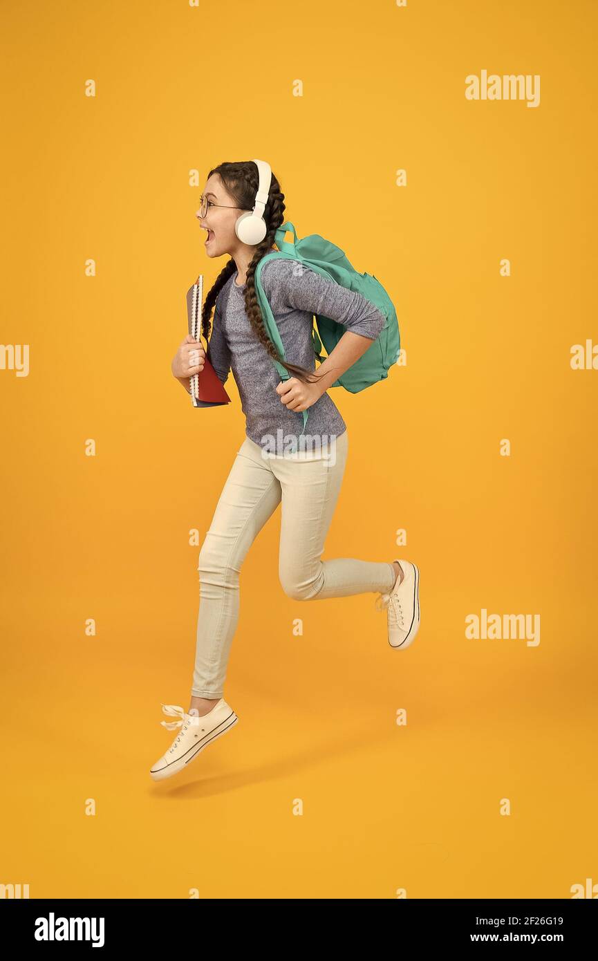 Full of energy. Energetic child run to school. Happy girl in motion ...