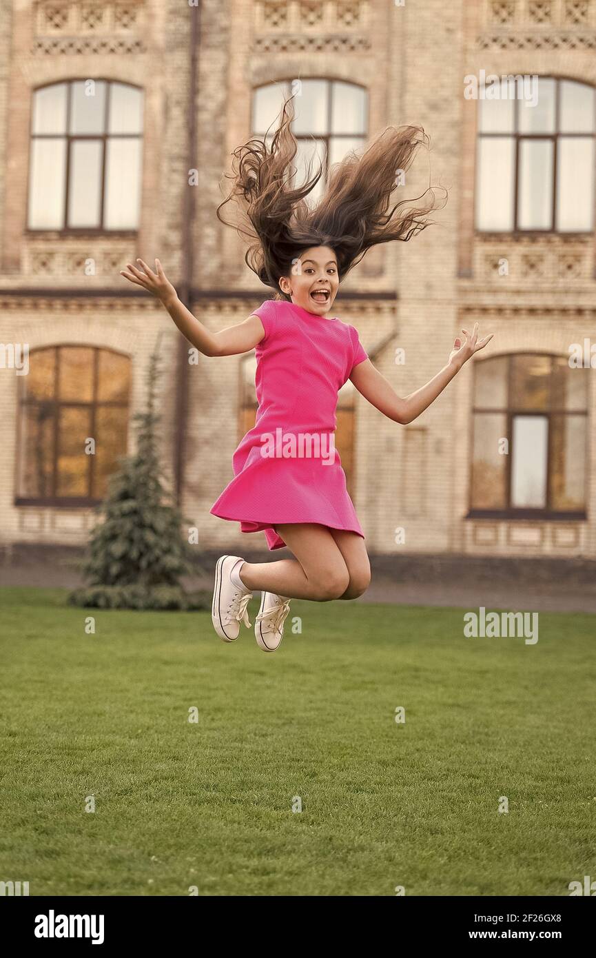 Girl jumping outdoors. Feel free. Jump of happiness. Small girl jump on ...