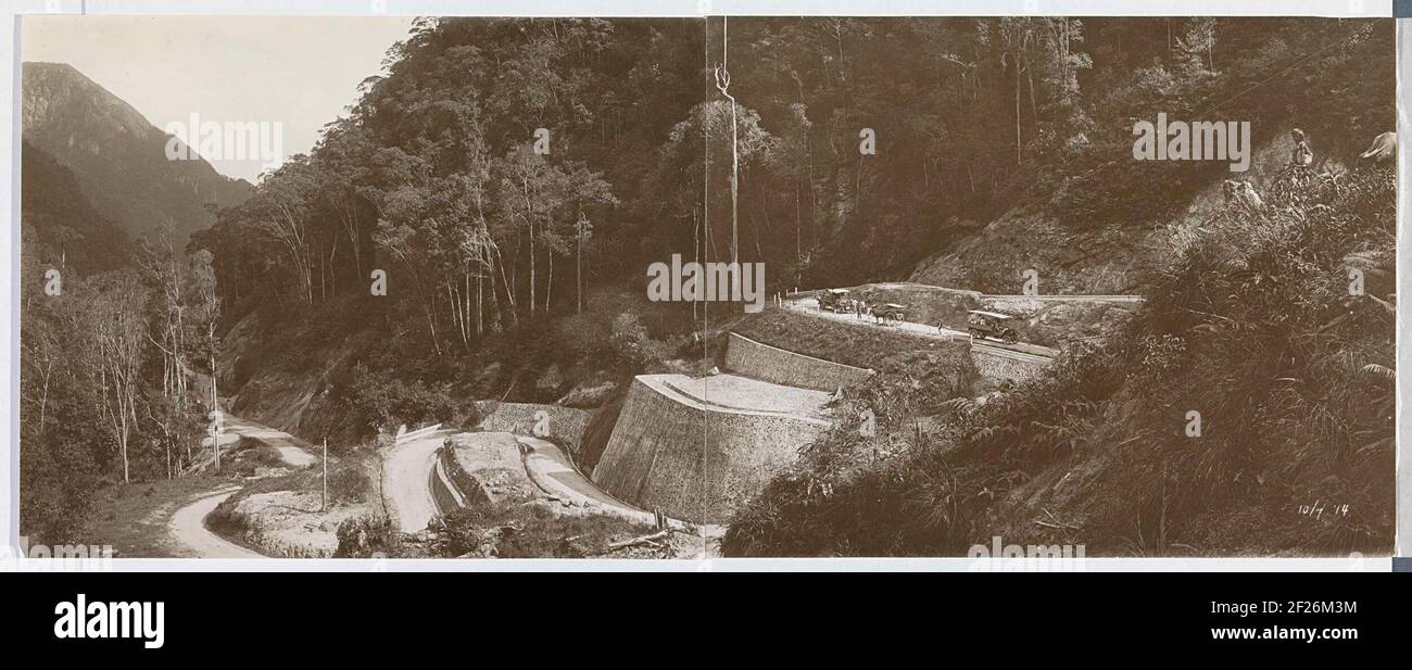 Path with hairpin bends, cars and a cart between Paja Kombo and ...