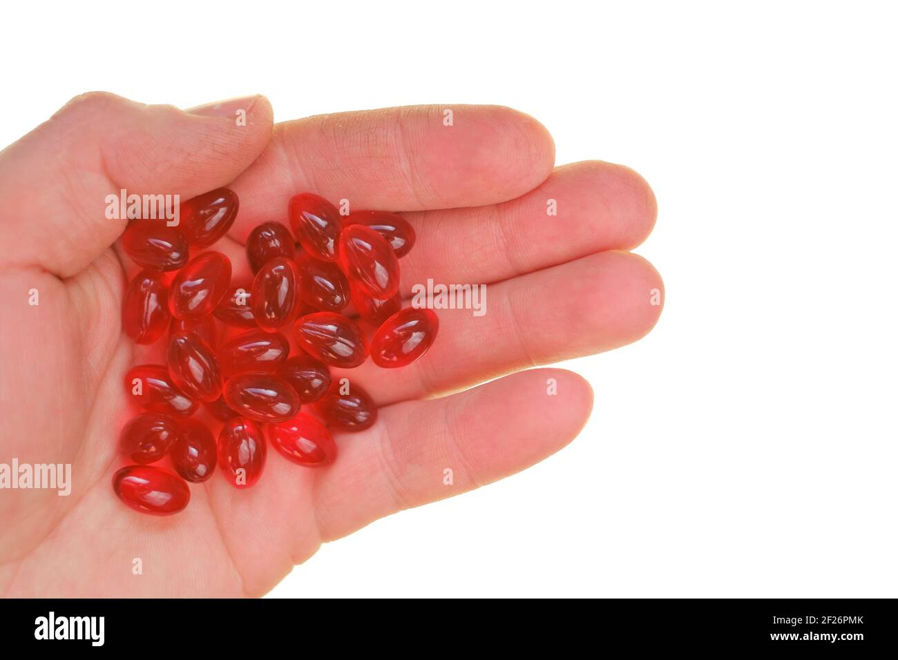 Krill oil capsules. Red capsules with krill oil in hand isolated on ...