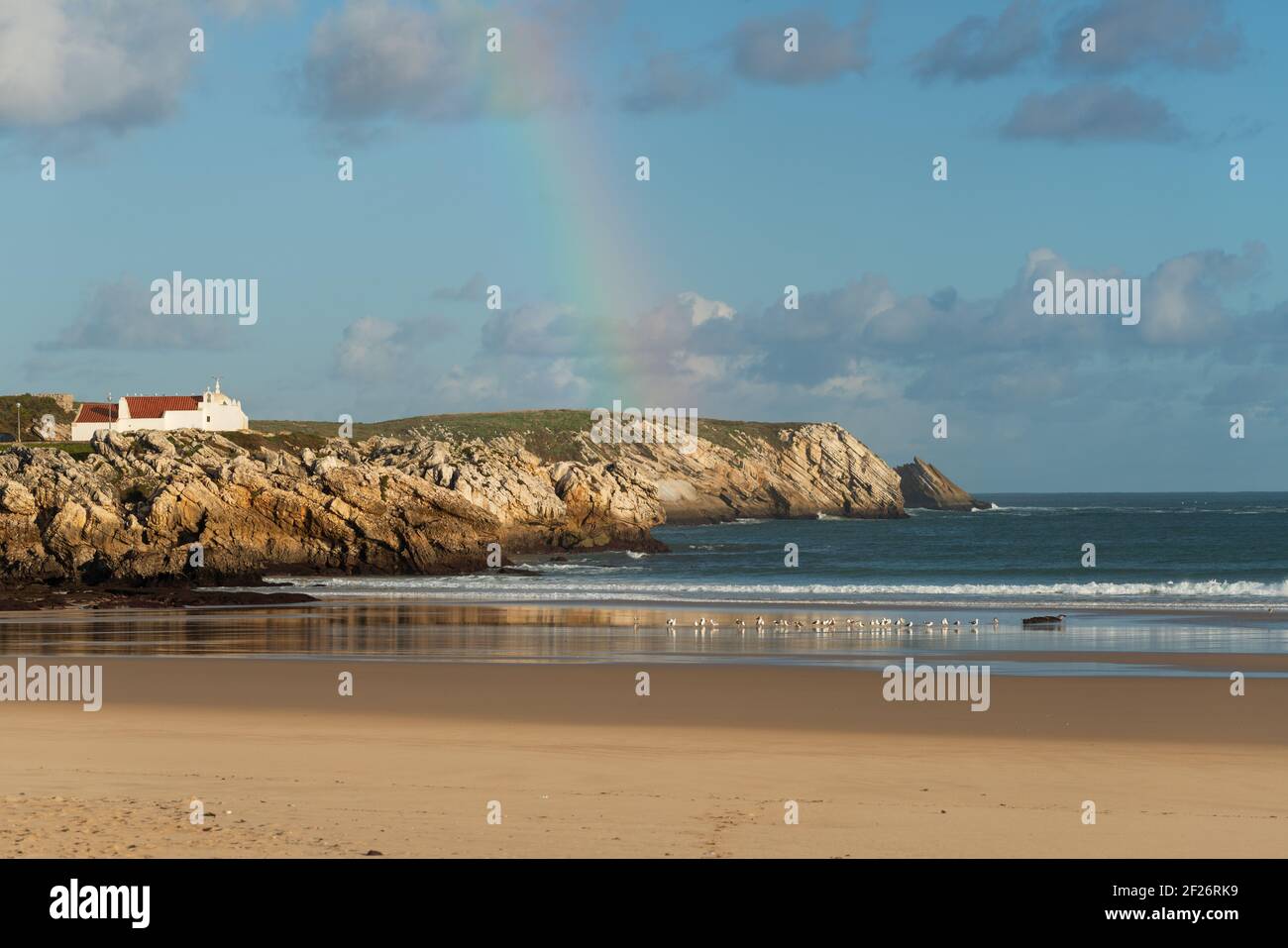 Baleal beach with atlantic ocean and rainbow in the sky and seagulls on ...