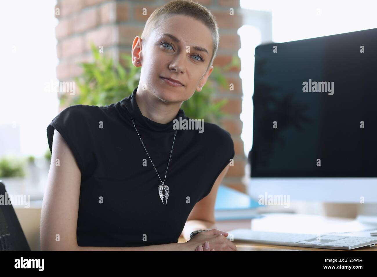 Closeup woman leader on brick wall background Stock Photo - Alamy