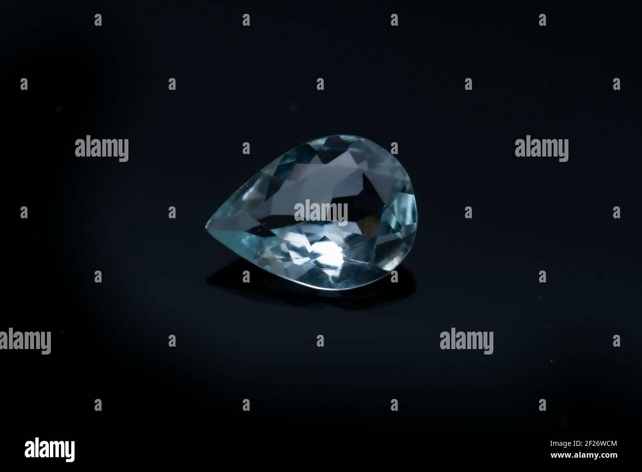 Natural stone blue topaz on a black background Stock Photo - Alamy