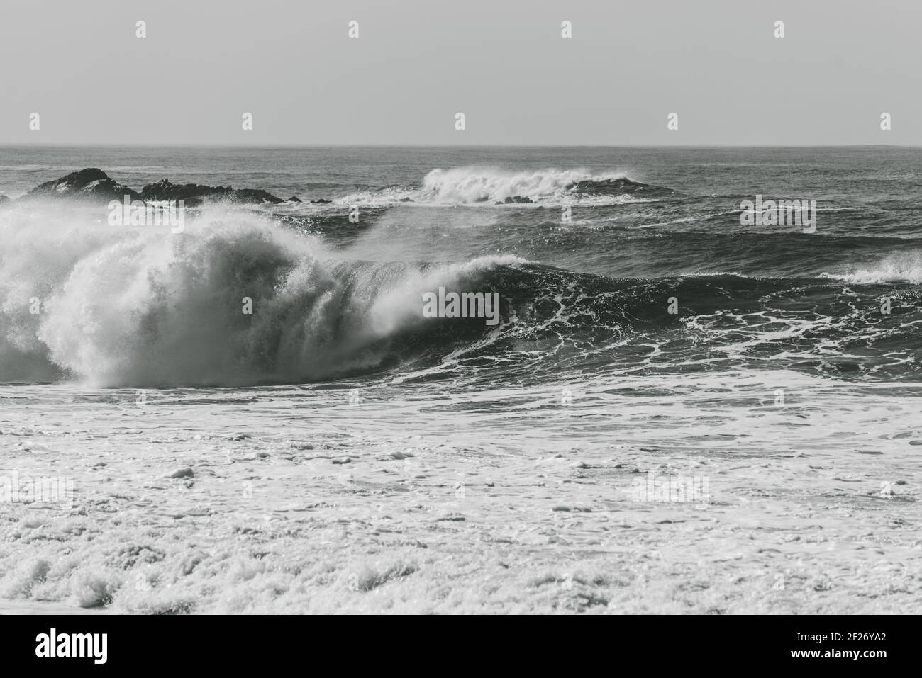 A grayscale shot of big waves crashing on the sea - perfect for ...