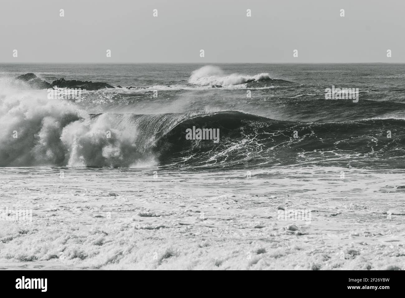 A grayscale shot of big waves crashing on the sea - perfect for ...