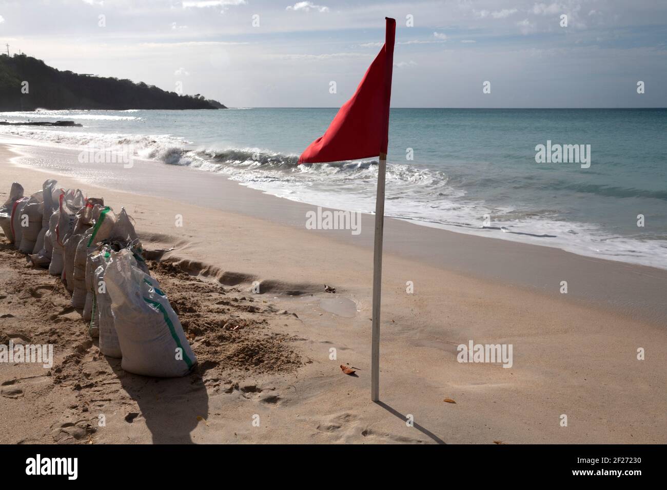 red flag and sacks of sand grand anse beach st george grenada windward ...