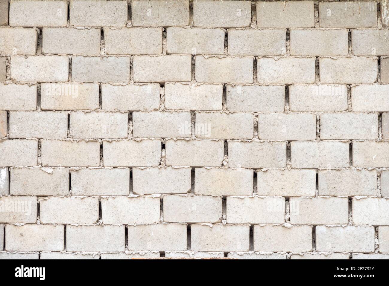 Wall with cement block brick, forming repetition mosaic Stock Photo - Alamy