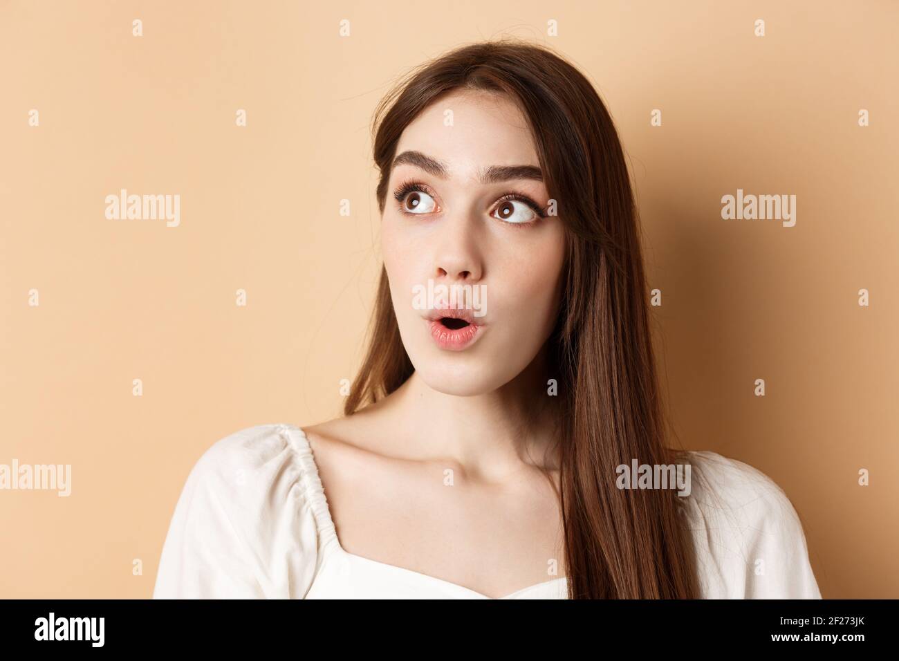 Close Up Portrait Of Excited Pretty Woman Looking Aside Logo Say Wow