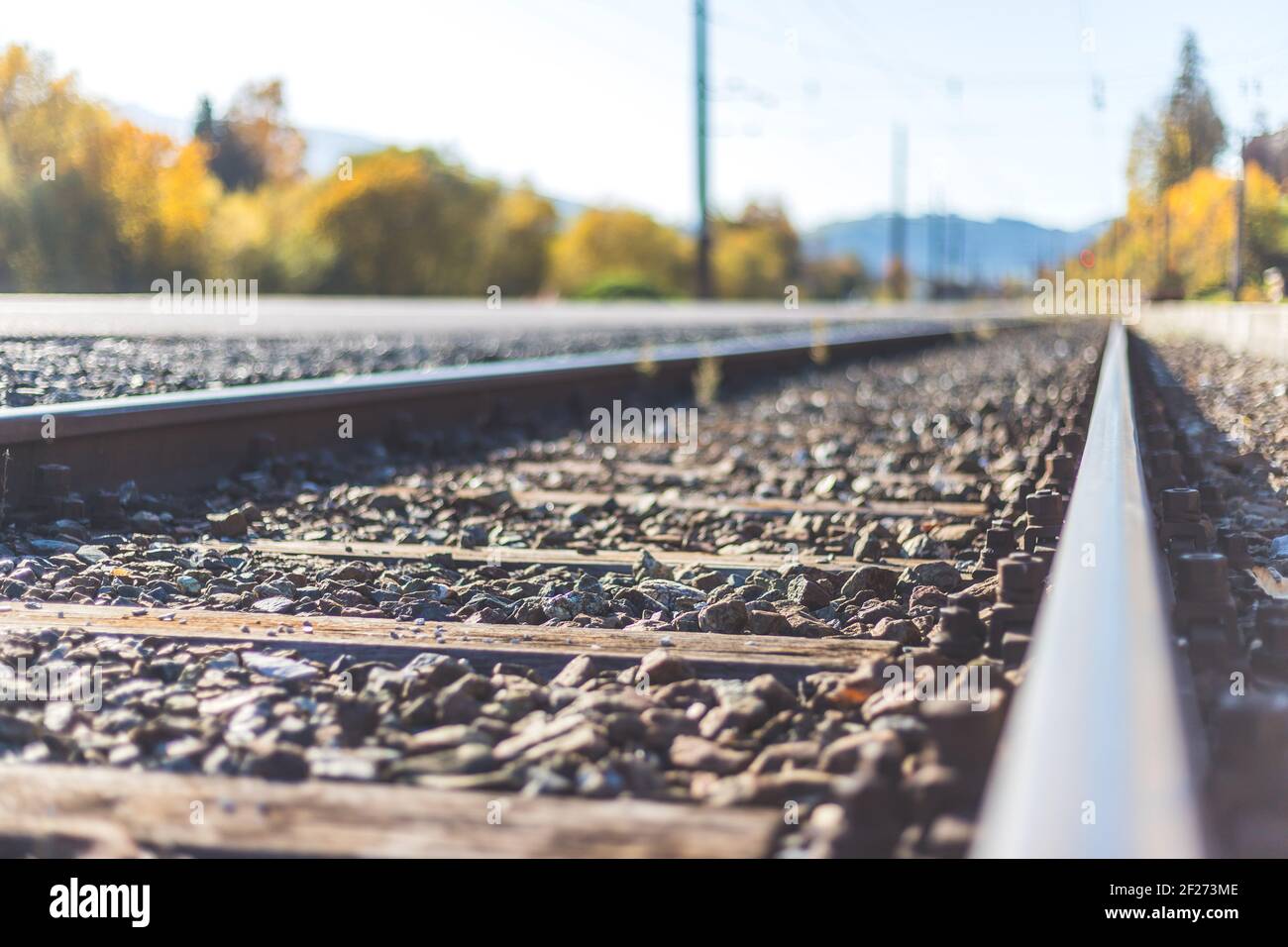 Sustainable traveling by train: Rail track and colorful, idyllic ...