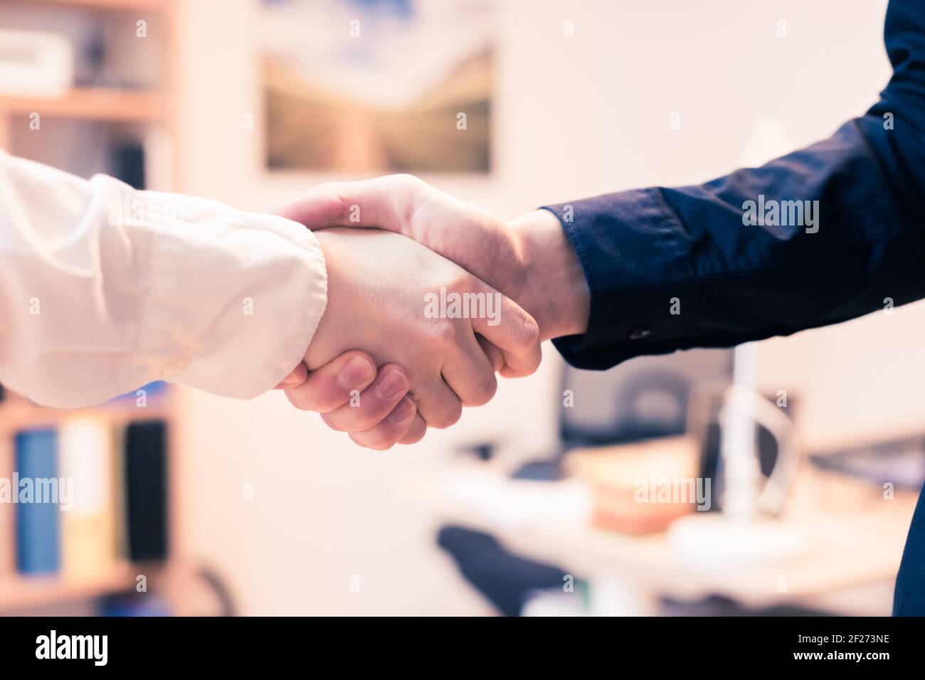 Shaking hands, concept for teamwork: Close up of man and woman shaking ...