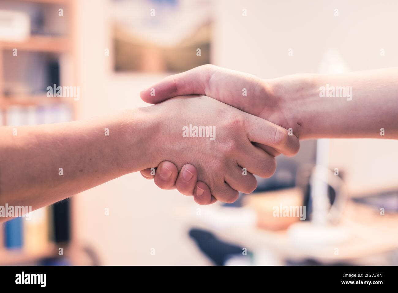 Shaking hands, concept for teamwork: Close up of man and woman shaking ...