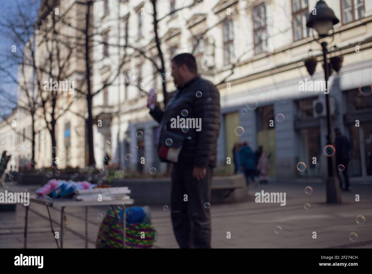Street vendor demonstrating a bubble blower toy Stock Photo - Alamy