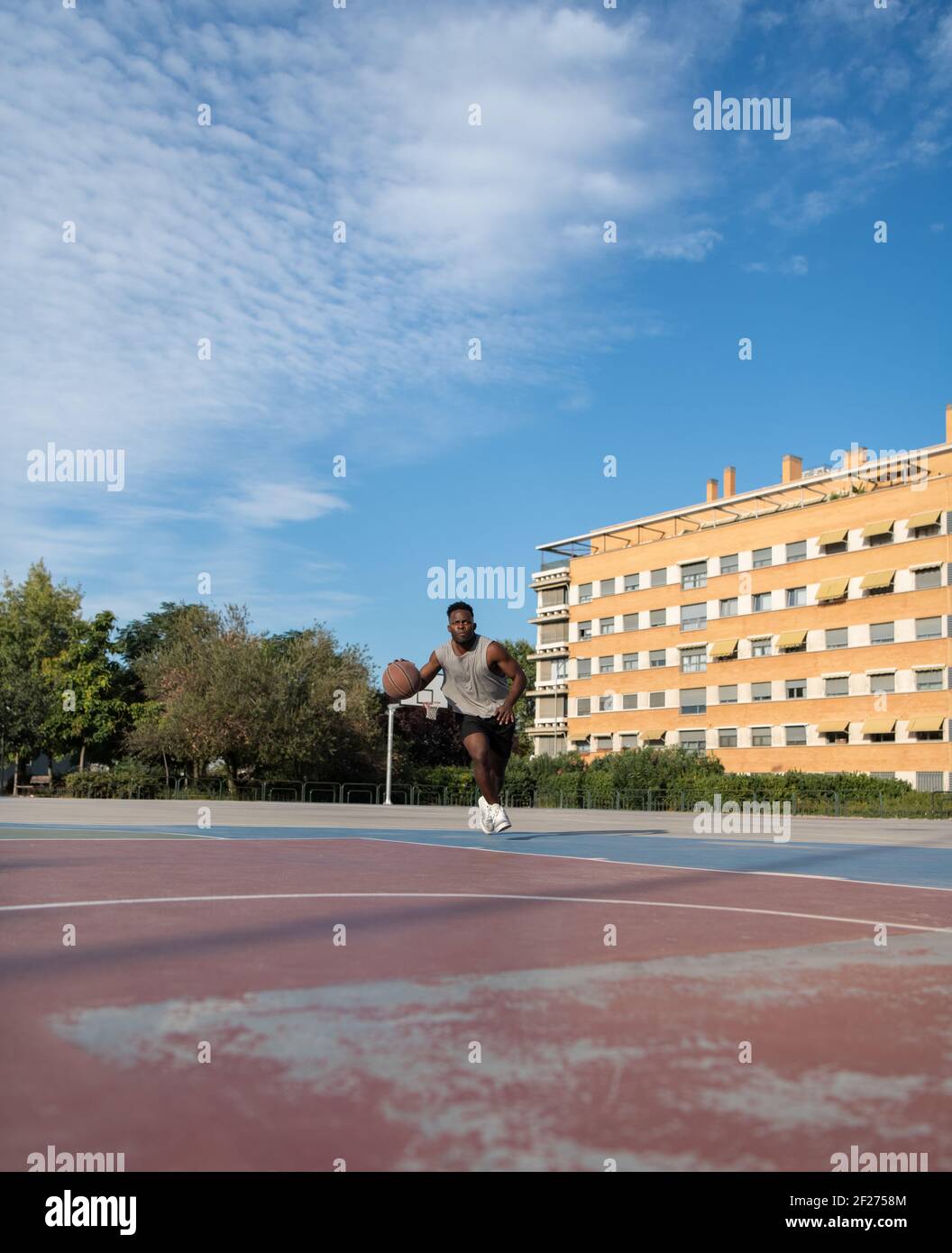 Black basketball player running with ball Stock Photo - Alamy