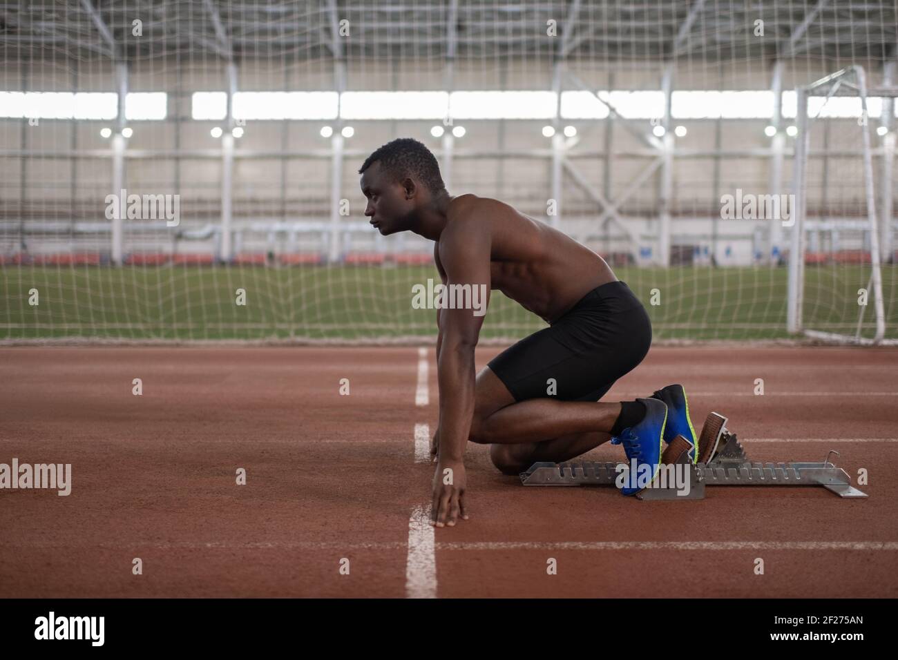 African American athlete in crouch start position Stock Photo - Alamy