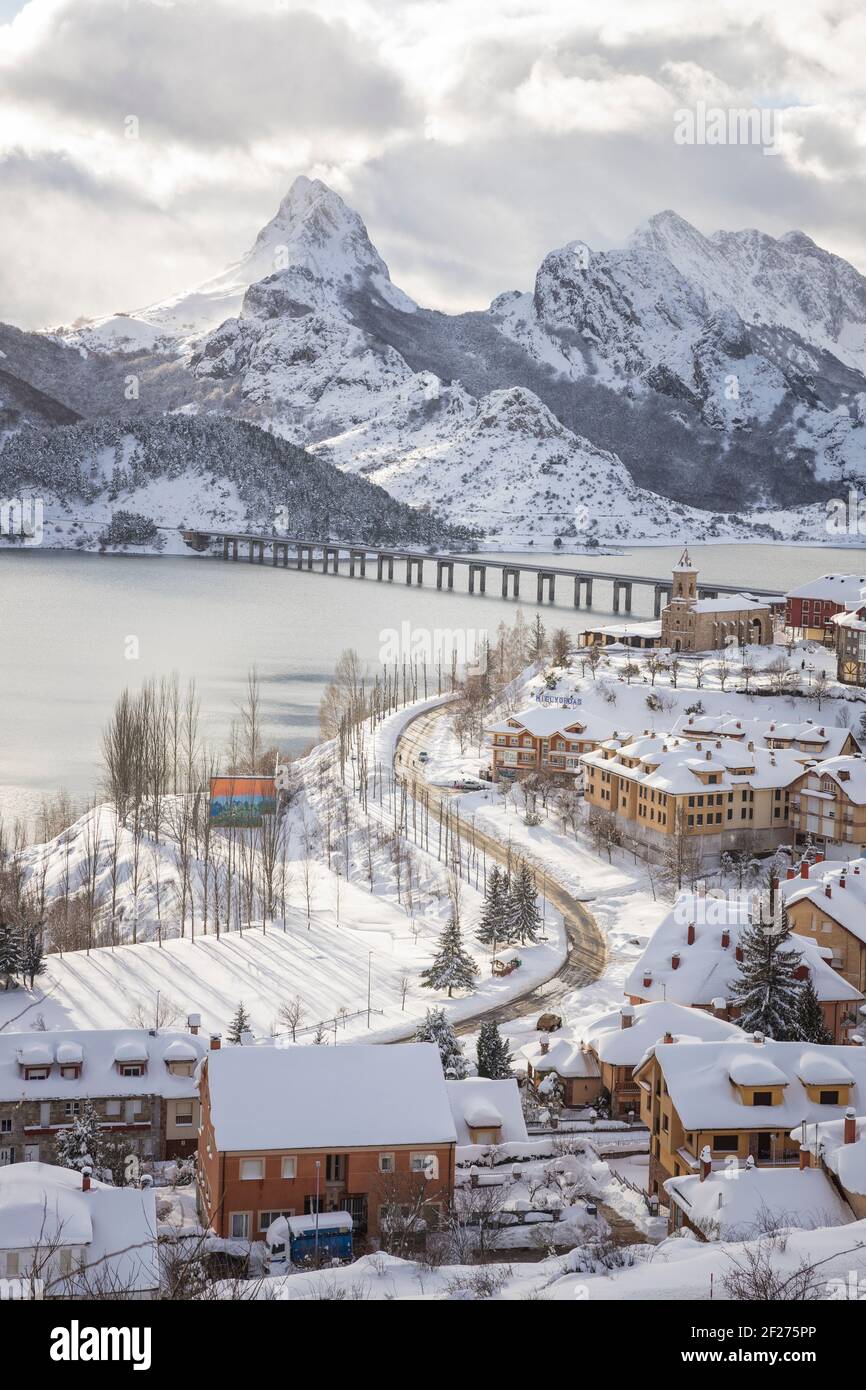 snowy high mountain town over full reservoir Stock Photo - Alamy