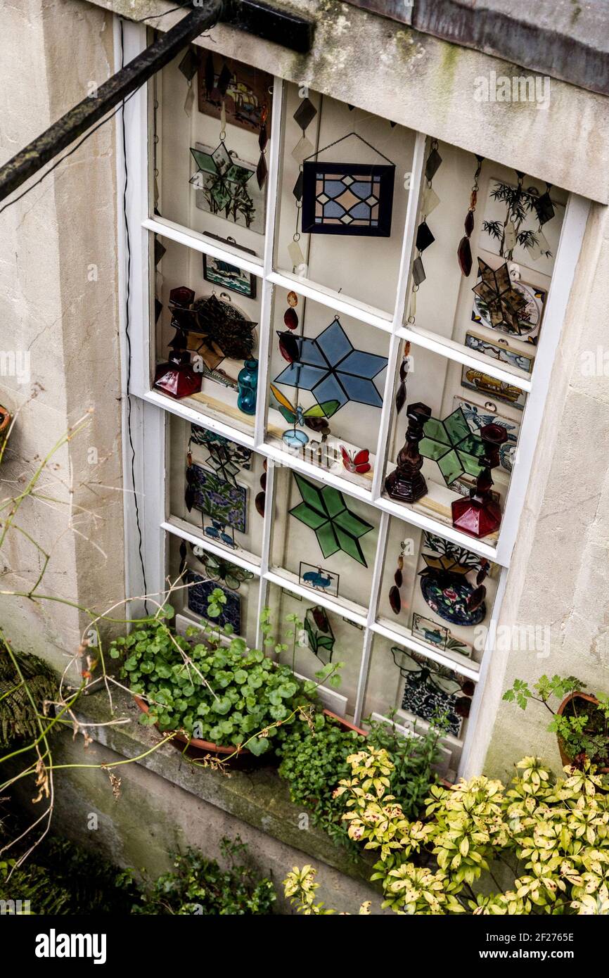 Basement white window with several crystal decorations Stock Photo - Alamy