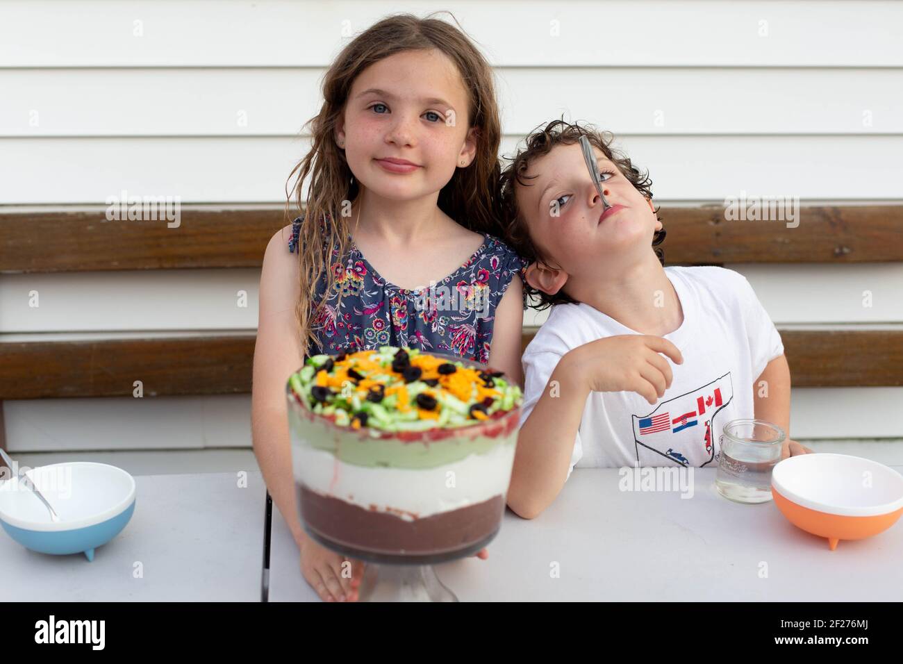Siblings eating dessert in their backyard Stock Photo - Alamy