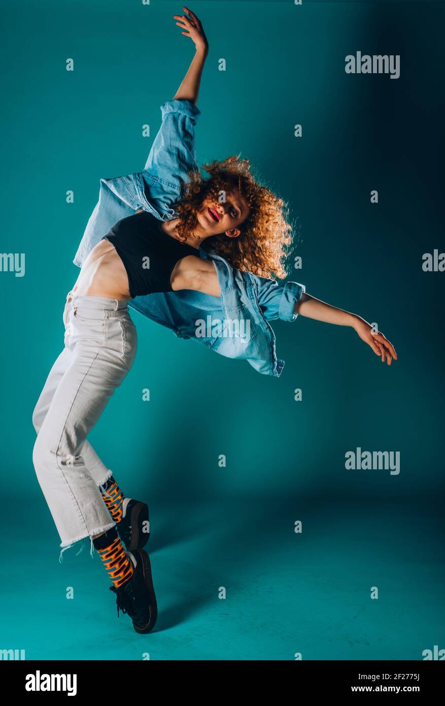 Slender flexible dance performer during a dance practice in modern ...