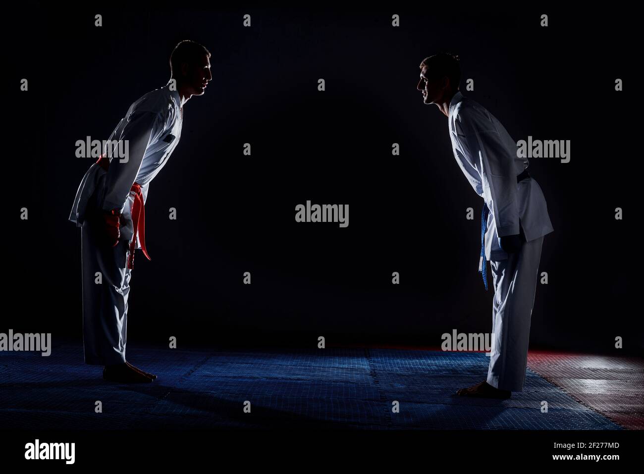 Strong fit athlete, karate men or fighters in white kimono, suit, with ...