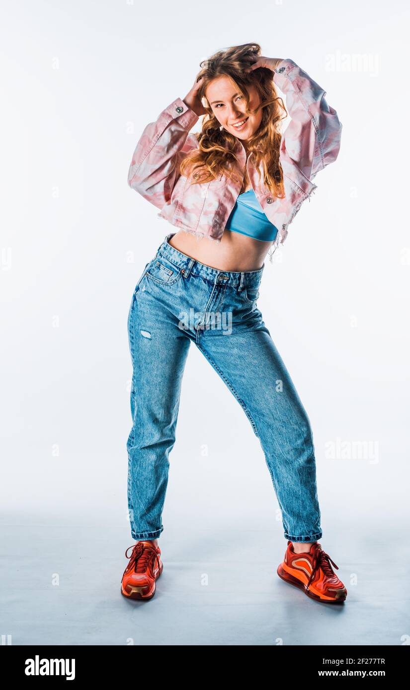 Portrait of a beautiful stylish girl posing in trendy modern clothes ...