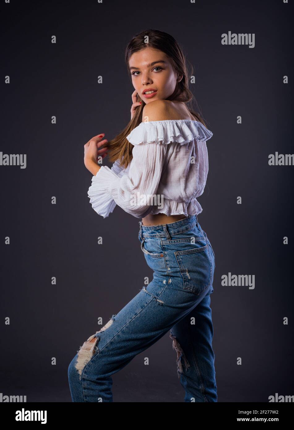 Body shot of an attractive female model posing in modern style clothes ...