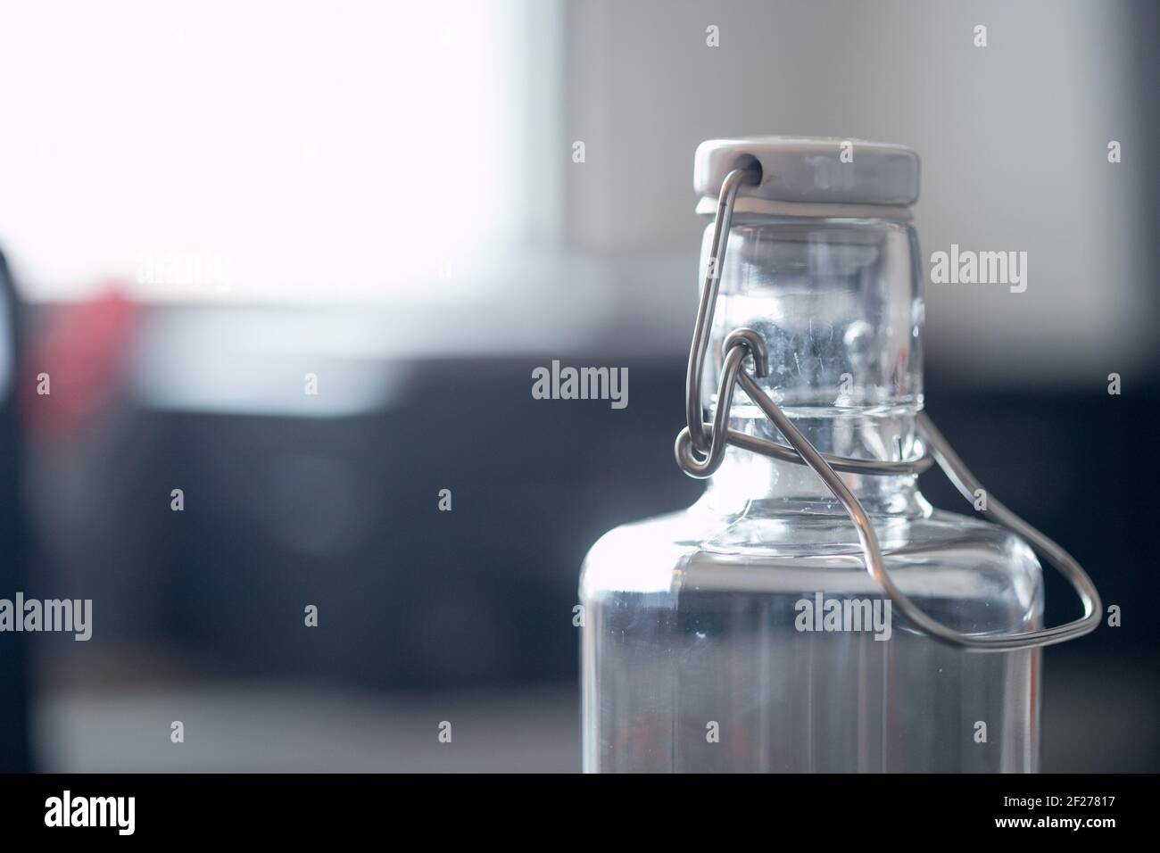 Drinking water in the office: close up of glass bottle, workplace Stock ...