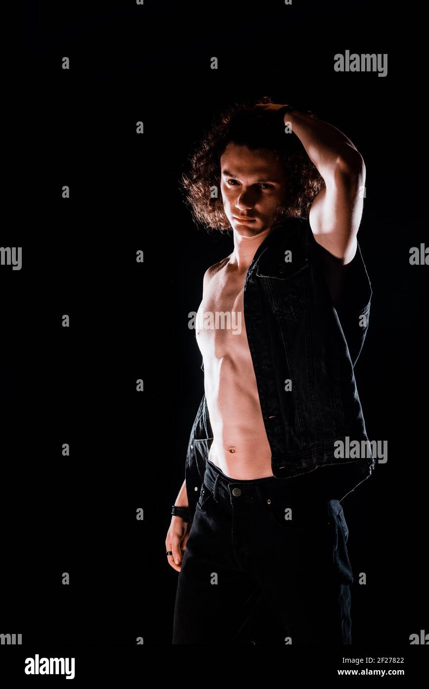 Studio body shot of a trendy young man wearing modern style clothes ...