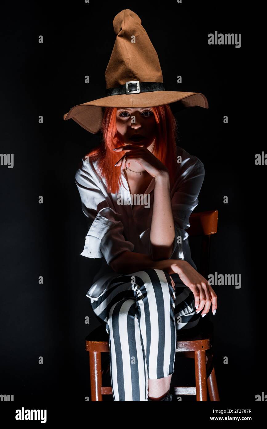 Stylish young woman wearing black and white pants and a witch hat Stock ...