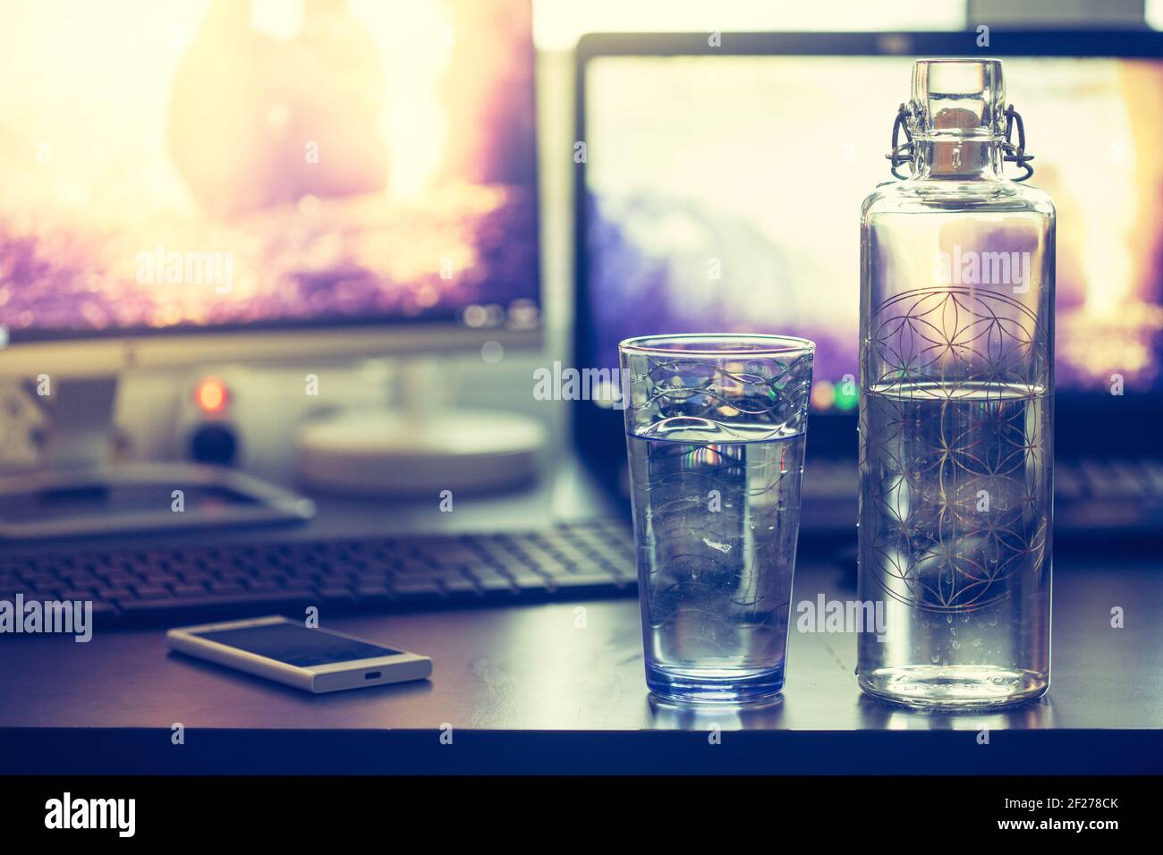 Drinking water in the office: close up of glass bottle, workplace Stock ...