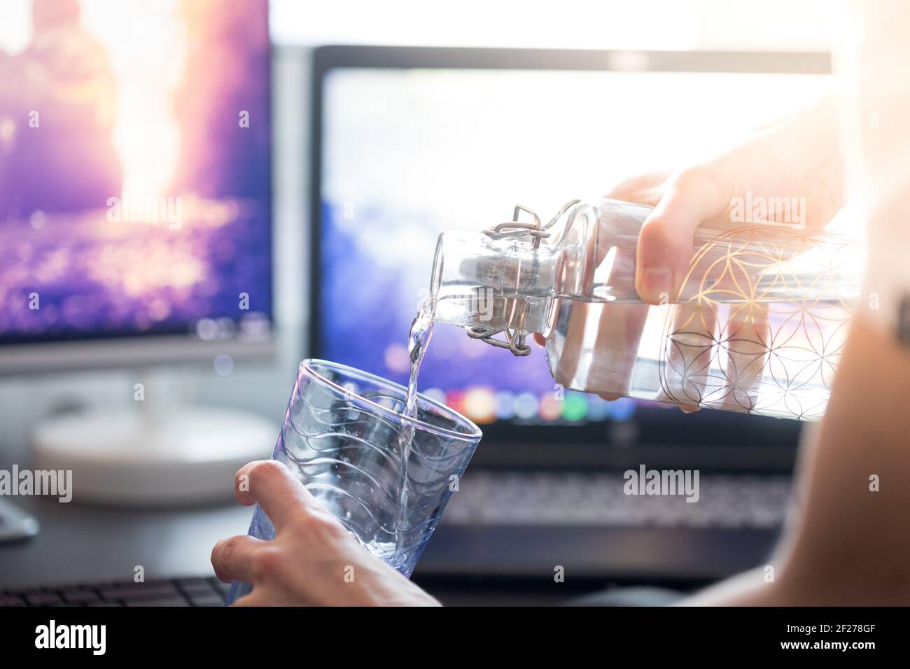 Drinking water in the office: close up of glass bottle, workplace Stock ...