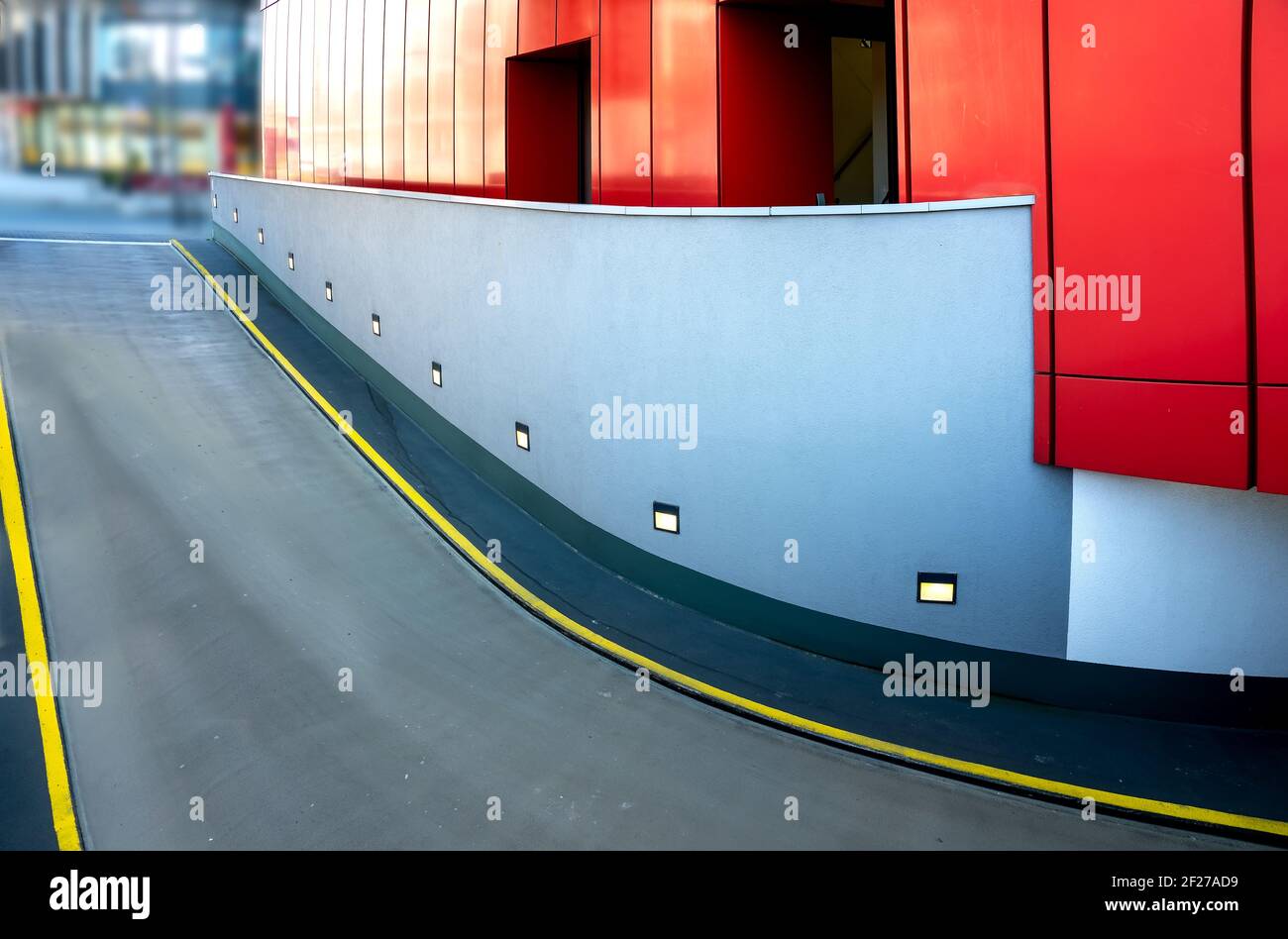 Entrance to an underground car park with modern red and grey wall ...